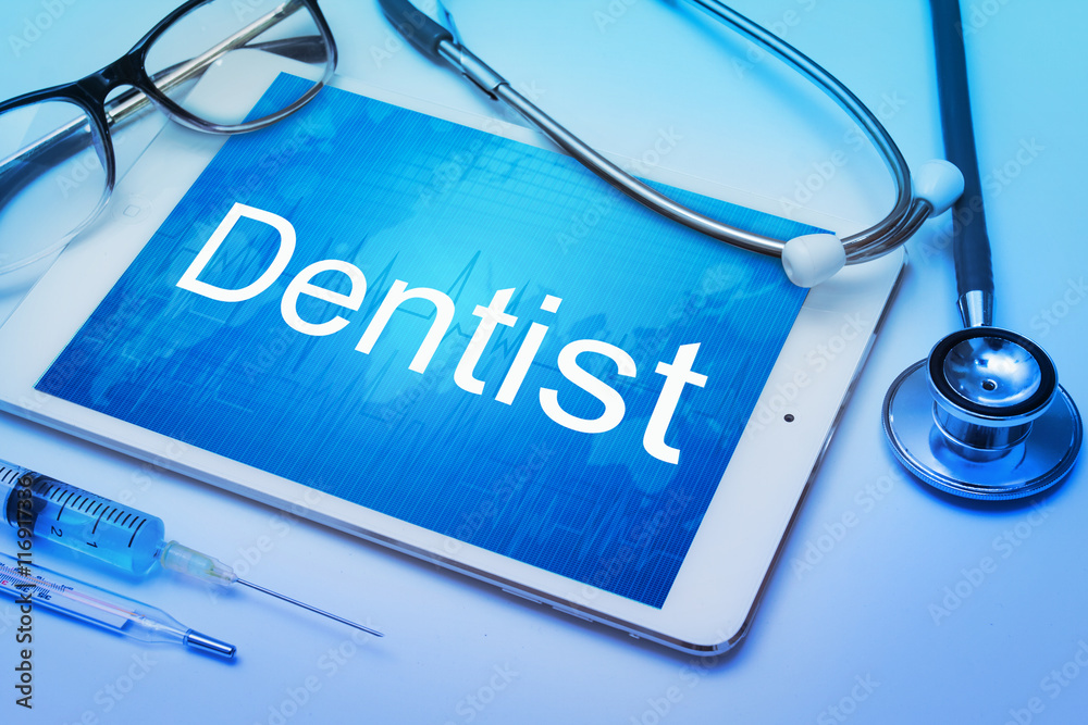 dentist word on tablet screen with medical equipment on background ...