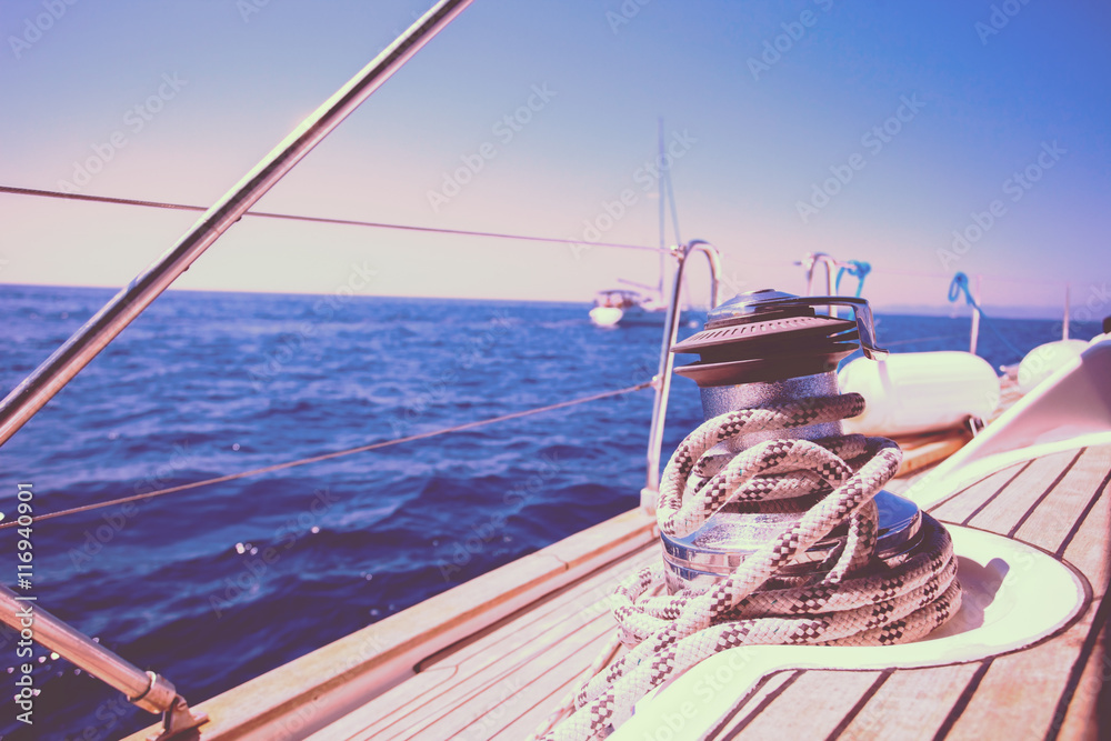 Coil of rope tied in a knot on a bollard. Coiled rope on boats deck ...