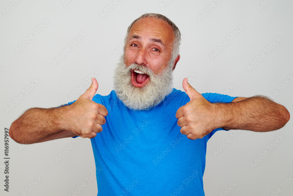 Smiling man with white beard giving two thumbs up Stock Photo | Adobe Stock