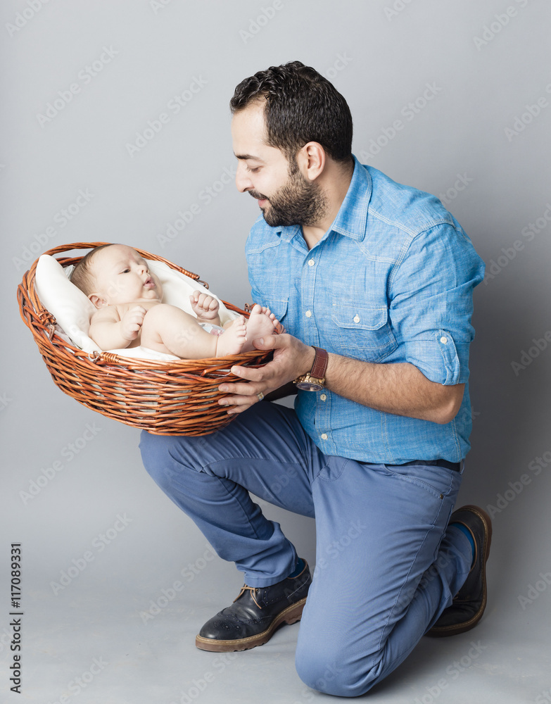 Young dad carrying his son inside wooden basket Stock Photo | Adobe Stock