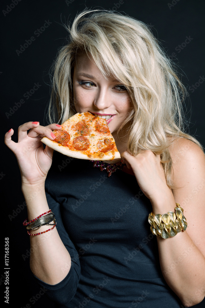 Young happy beautiful woman eating pizza. Pretty young sexy woman in ...