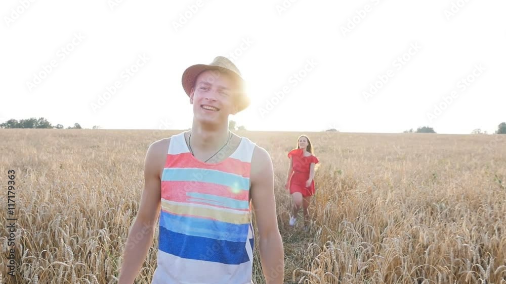 Young, happy couple have a piggy back in the field Stock Video | Adobe ...