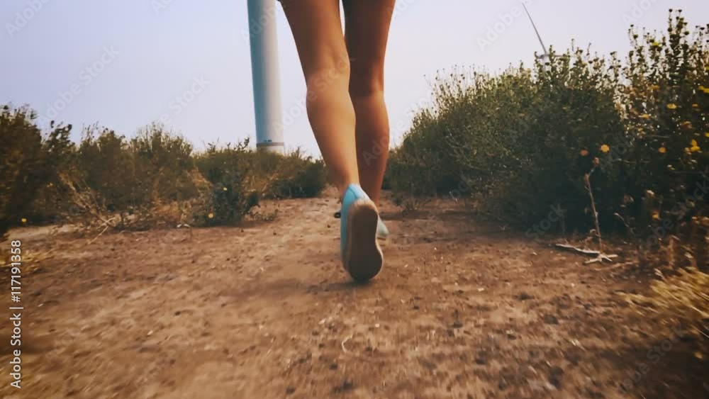 Happy girl running towards the wind turbine, slow motion. Stock ビデオ ...