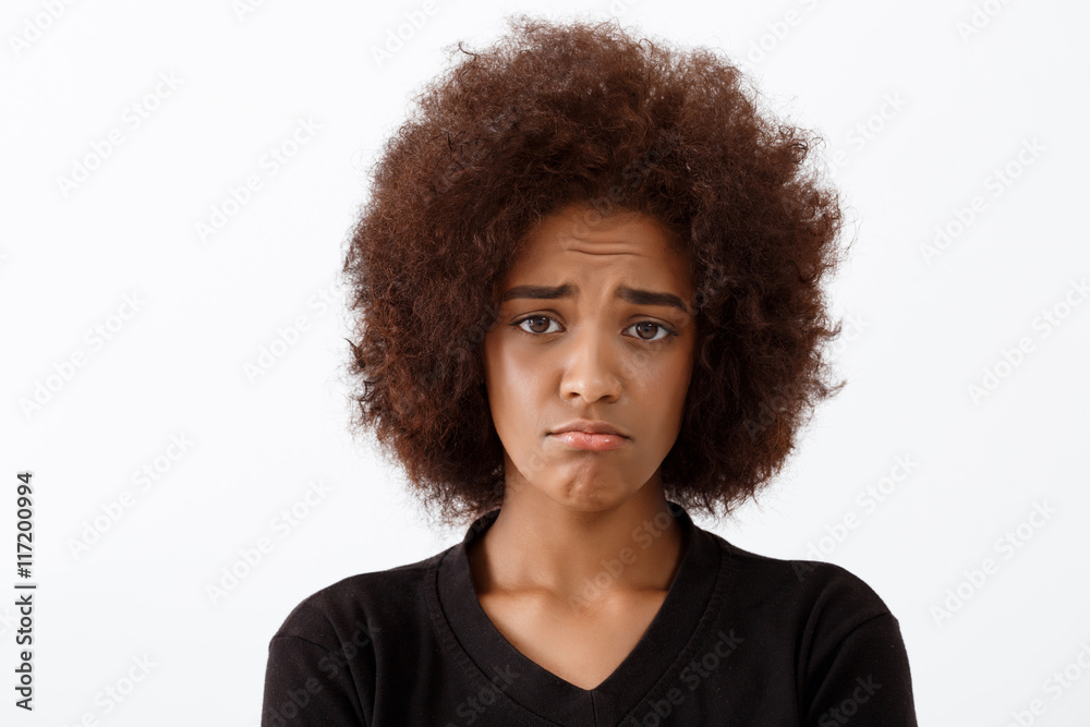 Upset beautiful african girl over light background. Stock Photo | Adobe ...