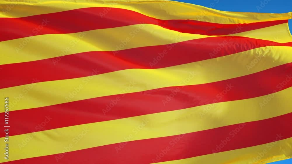 Catalunya flag waving in slow motion against clean blue sky, seamlessly ...