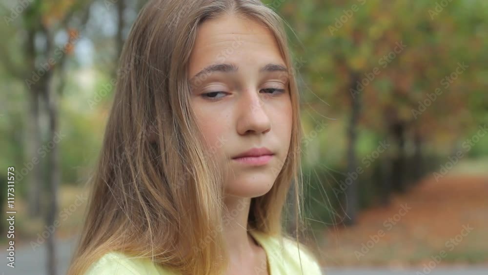 Pensive sad face portrait teen girl in autumn park Stock Video | Adobe ...