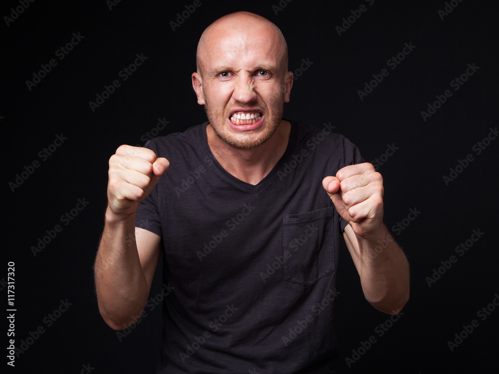 Close up portrait of an angry bald man, shaking his fists, black ...