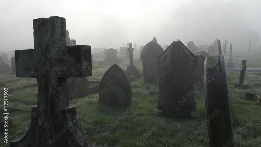 Spooky graveyard in the grounds of an old Chapel. Shot in early morning ...