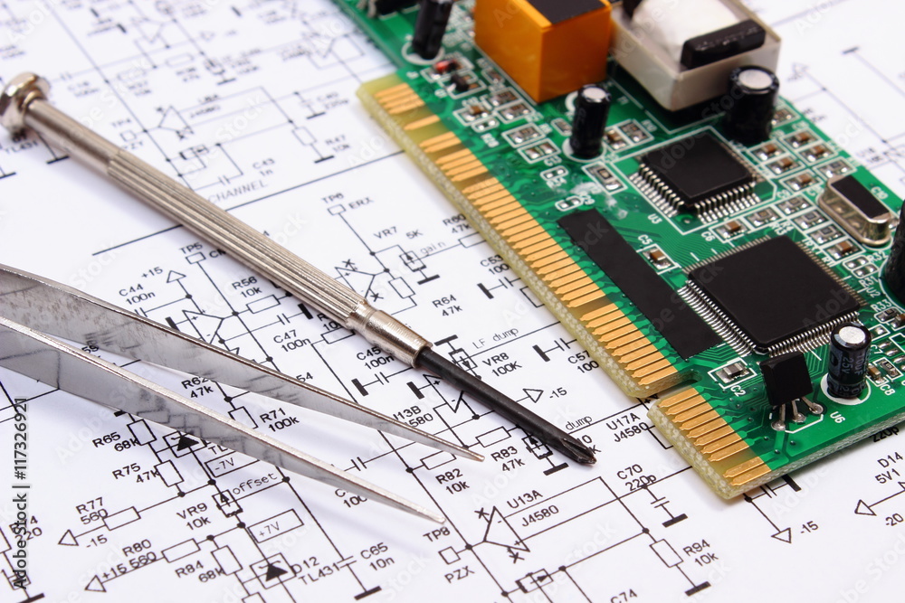Printed circuit board and precision tools on diagram of electronics ...