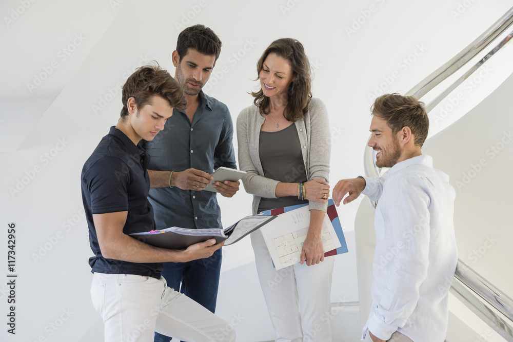 Happy colleagues discussing a file Stock Photo | Adobe Stock