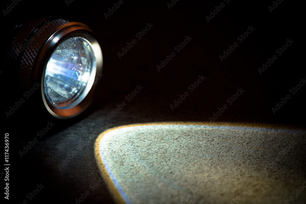 Flashlight and a beam of light in darkness. A modern led light with ...