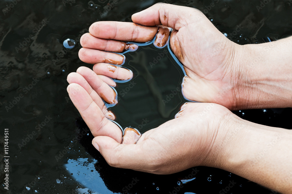 crude oil in hand due to crude oil leak.crude oil spill concept. Stock ...