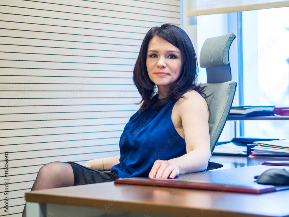 Beautiful Russian girl sits in an office chair boss Stock Photo | Adobe ...