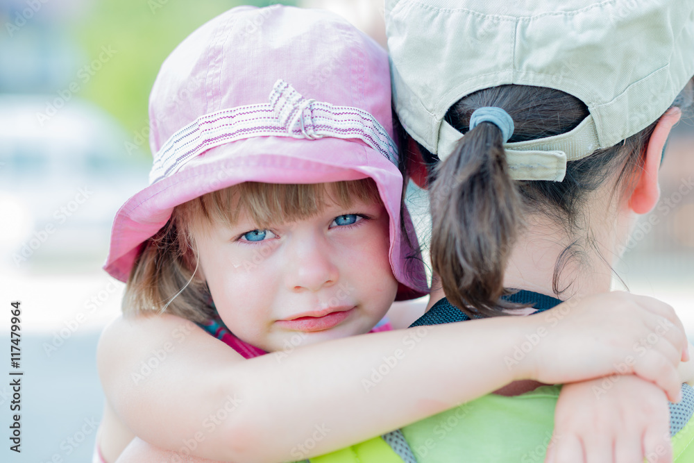 sad crying little girl hugging her mother Stock Photo | Adobe Stock