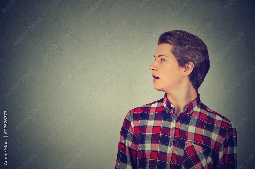 Side profile of handsome man with his mouth open, talking, singing ...