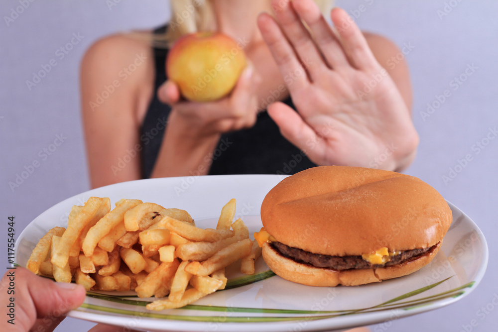 Woman refuses to eat junk food and choose fruits. Healthy eating and ...