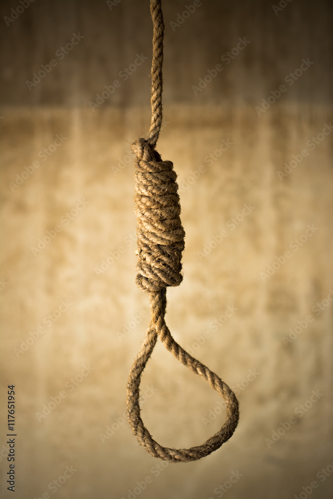 Noose in prison and wall grunge grain texture,Loop of old rope on wall ... Noose in prison and wall grunge grain texture,Loop of old rope on wall ...