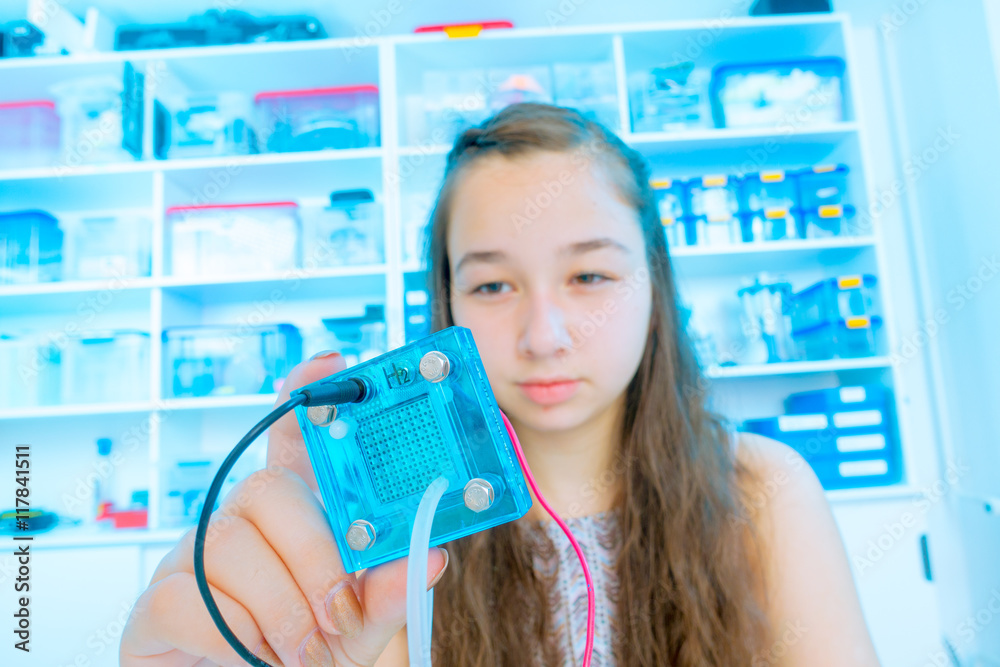 Student teen girl with experiment PEM proton exchange membrane ...