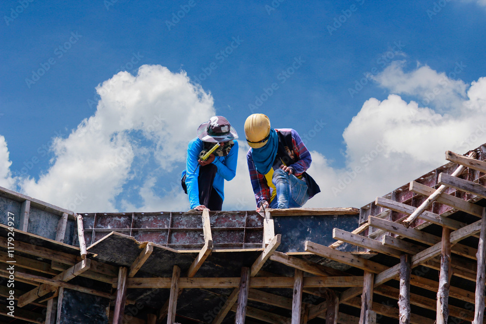 Construction workers collaborating in the installation of cement ...
