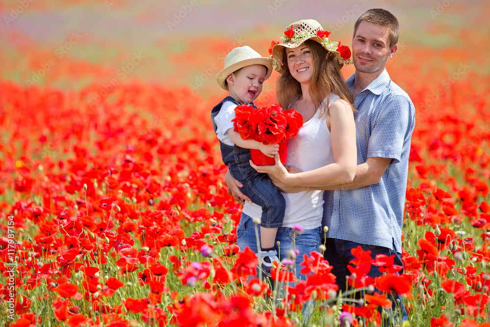 Happy family in a red flowers Stock Photo | Adobe Stock