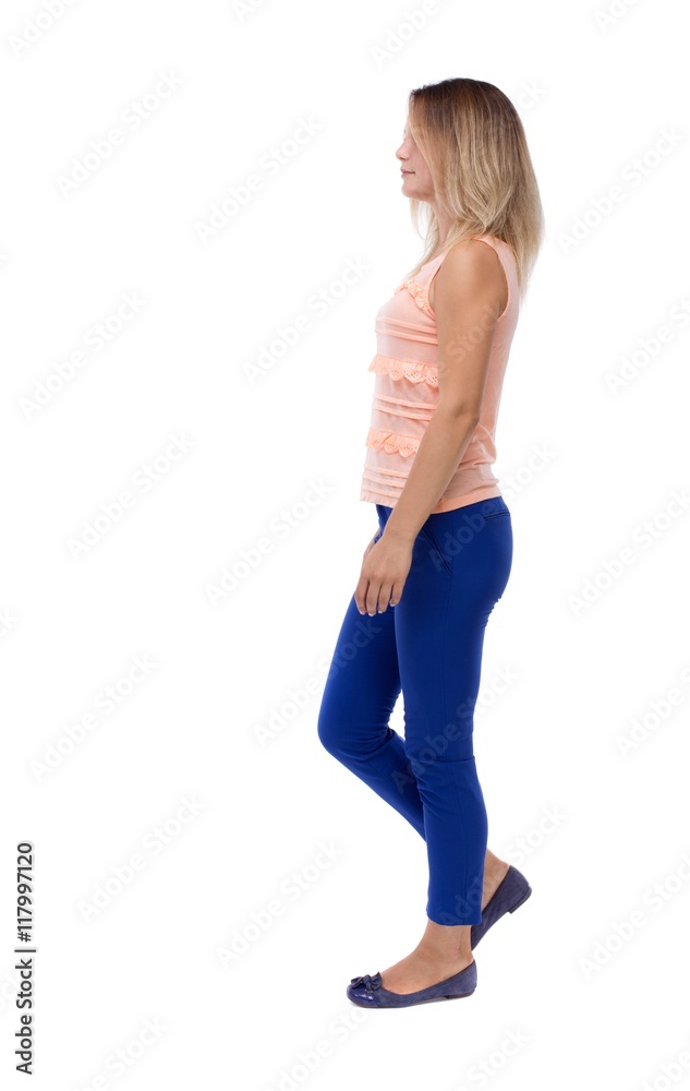 back view of walking woman. beautiful blonde girl in motion. backside ...
