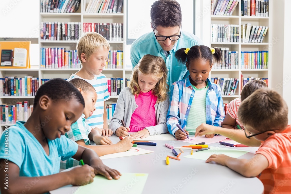 Teacher helping kids with their homework in library Stock Photo | Adobe ...