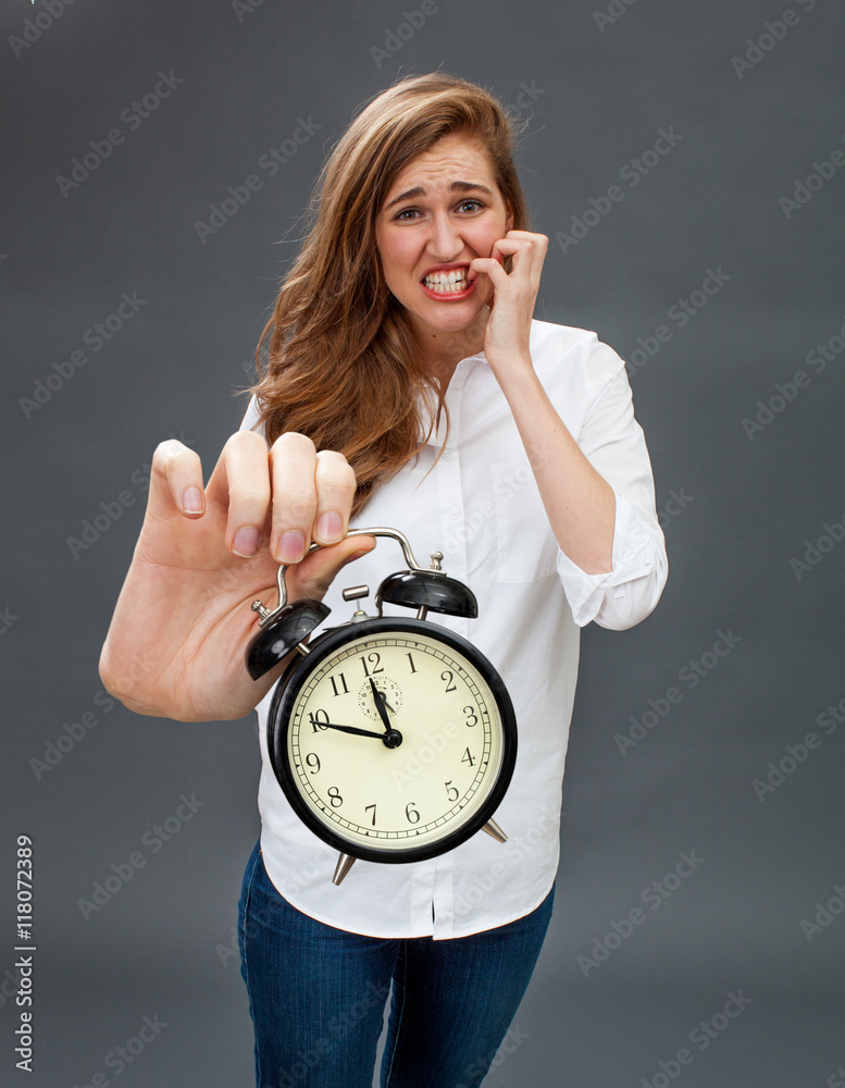 panicking girl showing embarrassing alarm clock for tensed time ...