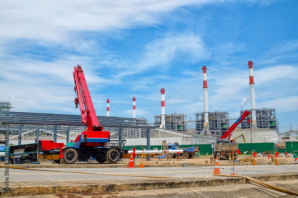 Mobile crane against demolition site or construction site of pow Stock ...