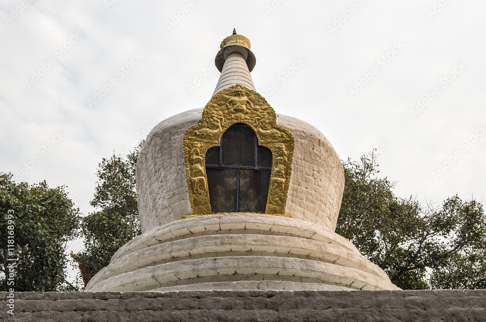 Large white-washed stupa and bodhi tree in the first courtyard of ...