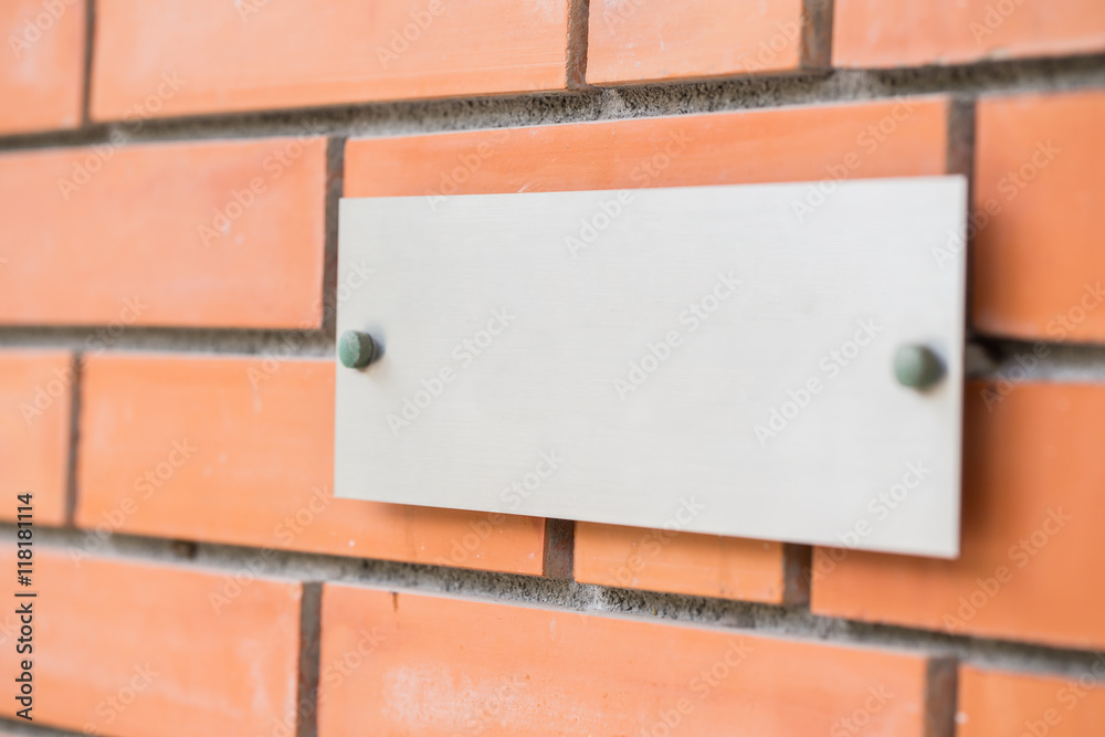 steel or aluminum company name plate with brick wall background or ...