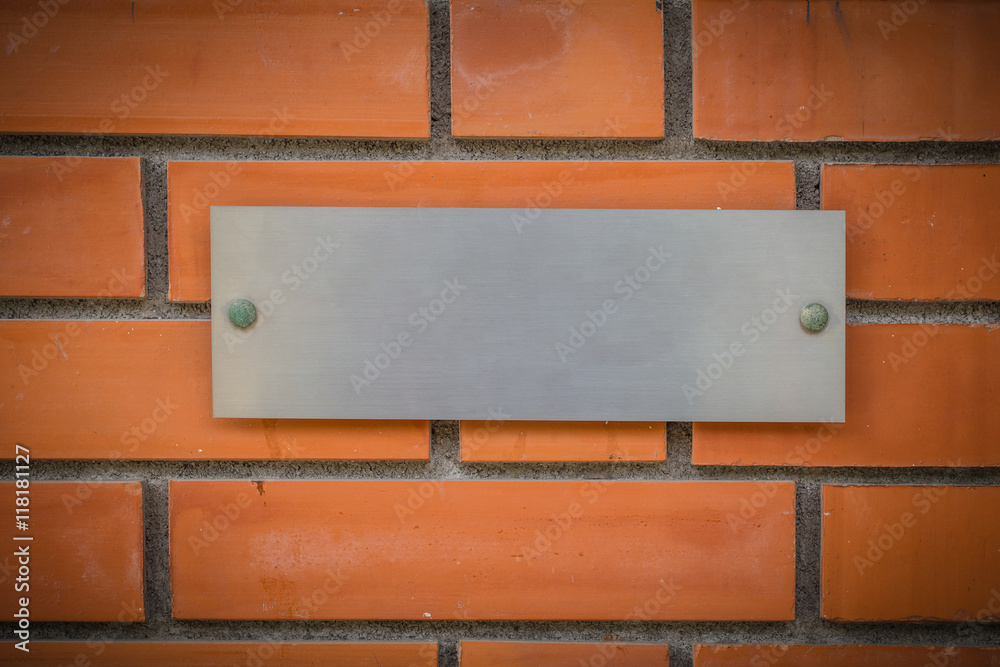 steel or aluminum company name plate with brick wall background or ...