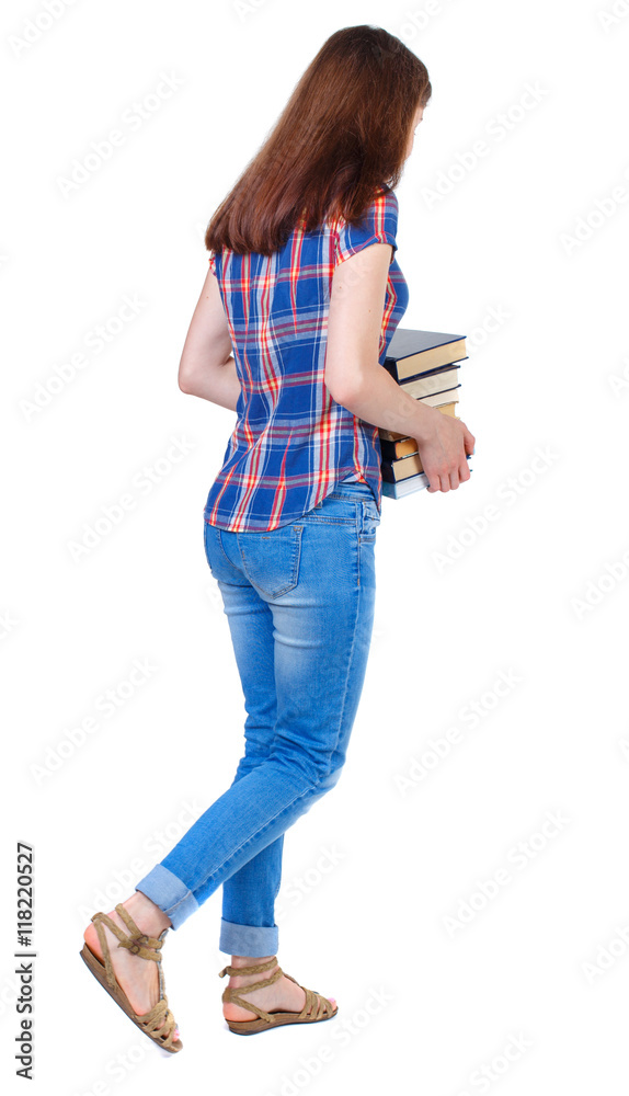 Girl comes with stack of books. back side view. Rear view people ...