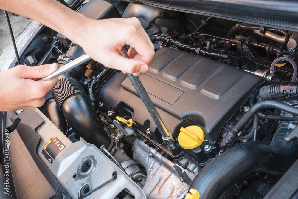 Hands repairing a modern car engine with a wrench Stock Photo | Adobe Stock