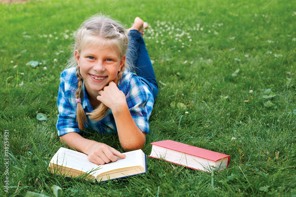 Girl Laying In Grass Reading
