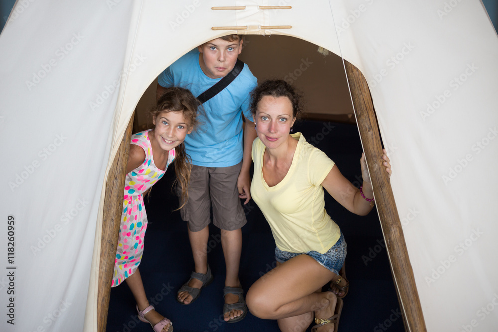 Family of three are standing into tepee in National Museum of the ...