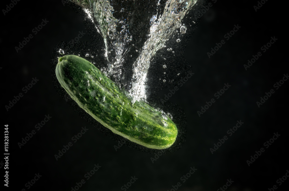 Fresh Cucumber with water splash on black background with air bubbles ...