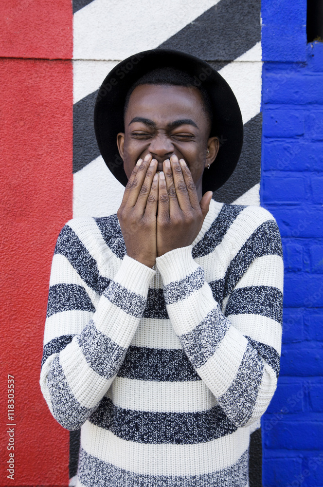 Black man laughing near colorful wall Stock Photo | Adobe Stock