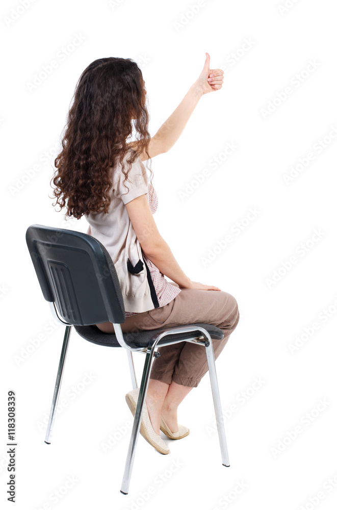 Back View Of Young Beautiful Woman Sitting On Chair And Thumbs Up Girl Watching Rear View