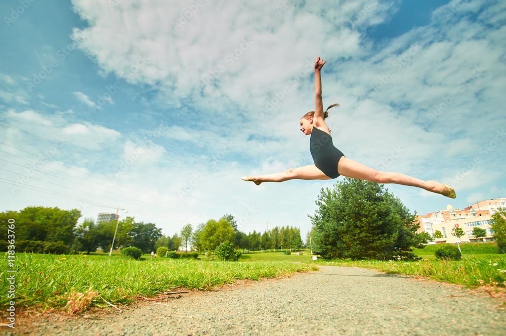 Young beautiful preteen girl doing gymnastics outdoors Stock Photo ...