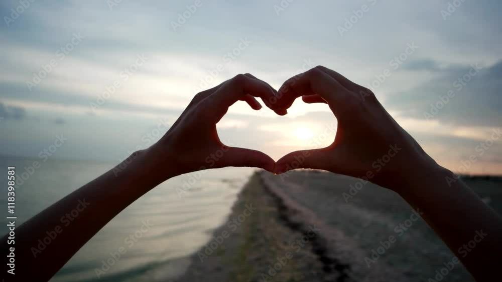 hands show heart at sunset. a sign of love, heart, girl shows the heart ...