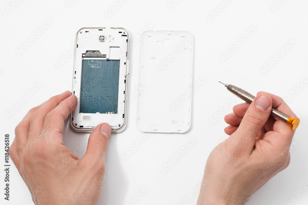 Smartphone disassembling with special tools. Phone repair service, male hand removing plastic ...