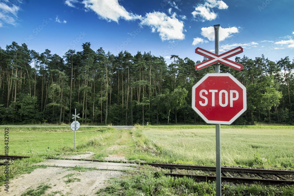 Stop Sign on Unguarded Rail Road. Road Across Rails with Field, Forest ...