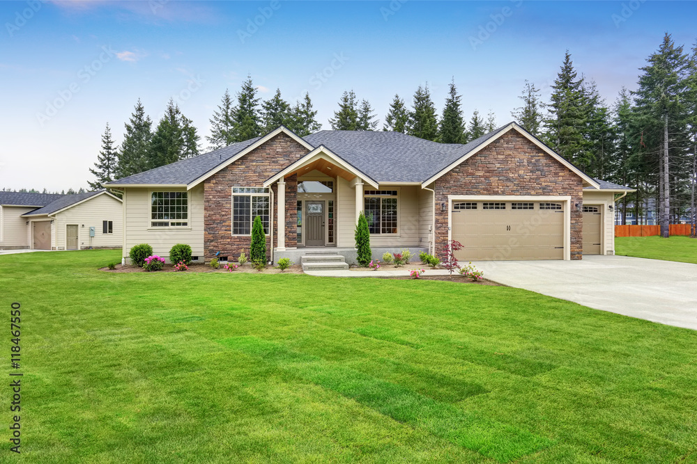 Luxury one level house exterior with brick trim and garage Stock Photo ...