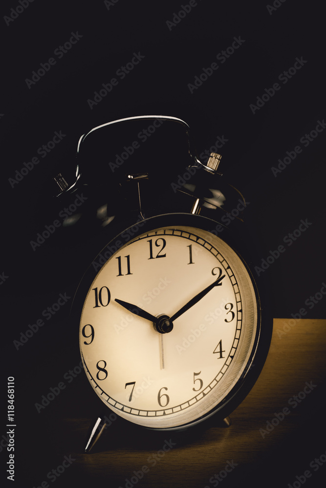 Time is up - alarm clock standing isolated on black background. with ...