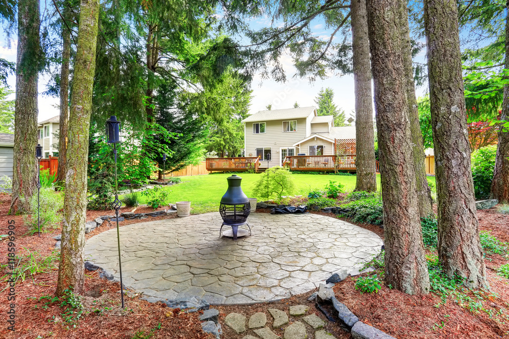 Fenced back yard with well kept garden. Stock Photo | Adobe Stock