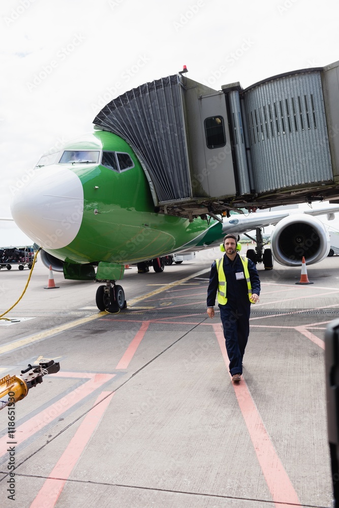 Airport ground crew walking on runway Stock Photo | Adobe Stock