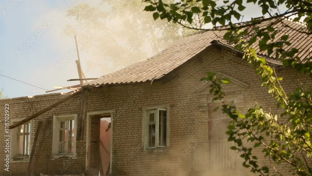 Demolition old house. excavator destroys old brick two-storey building ...