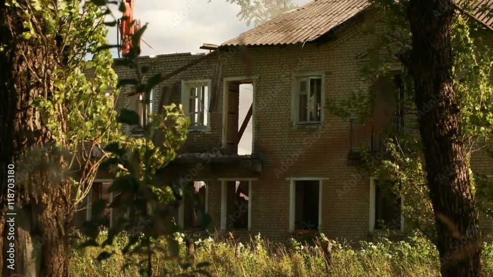Demolition old house. excavator destroys old brick two-storey building ...
