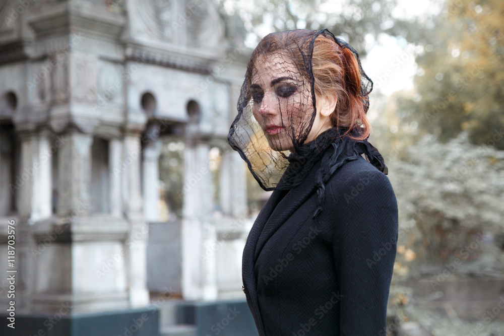 Portrait of a grieving woman in black with a veil on his face in the ...