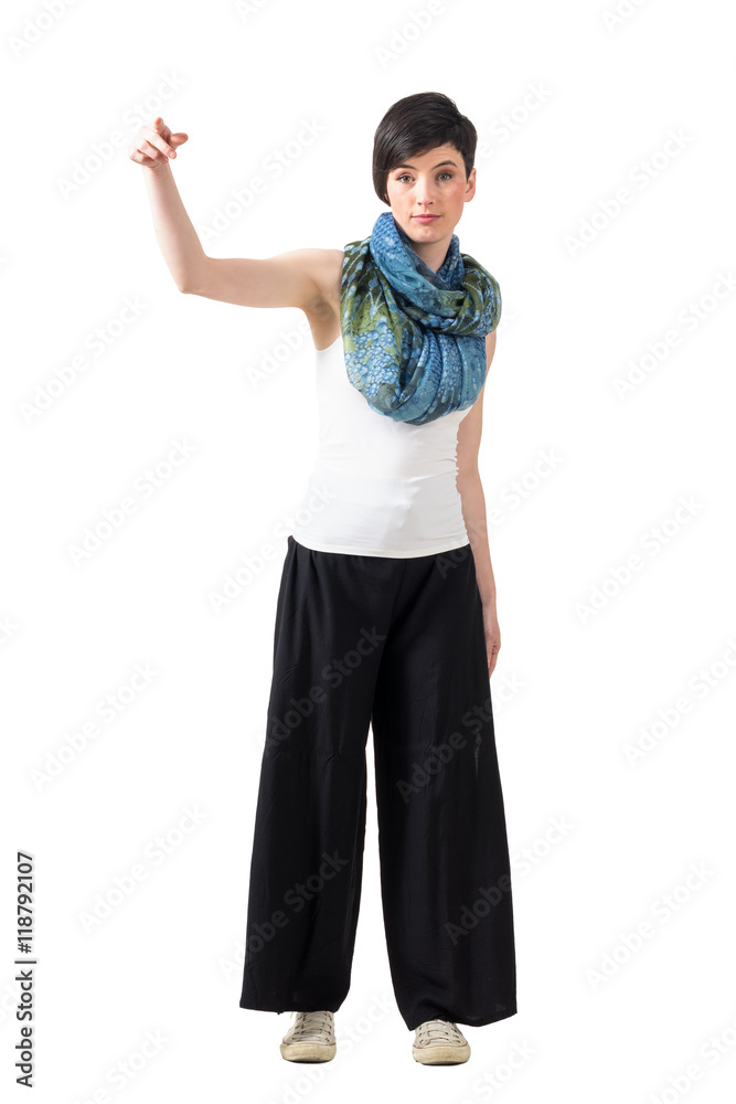 Cute young woman pointing finger at camera in gangster posture. Full ...